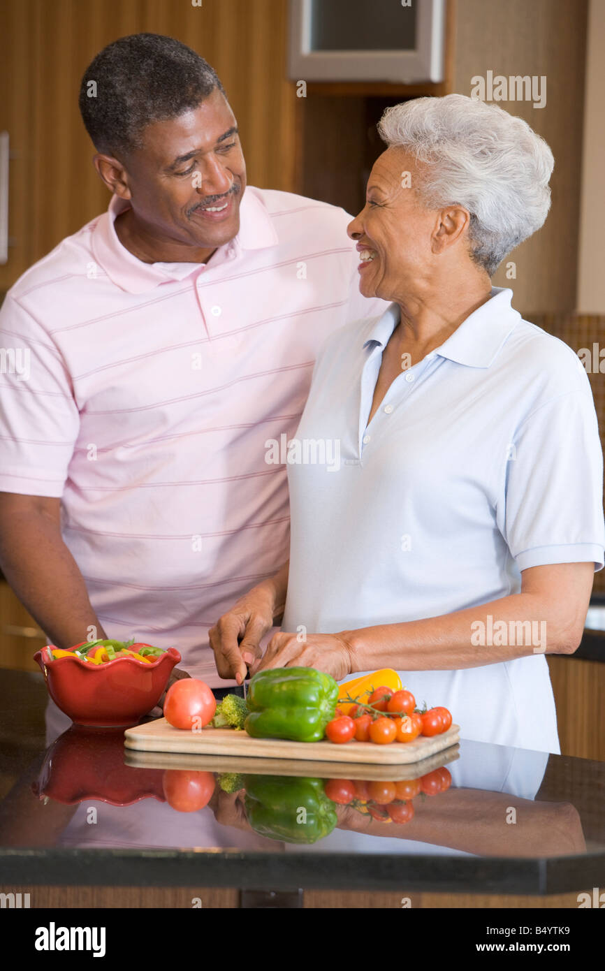 Husband And Wife Preparing Meal Together Stock Photo - Alamy