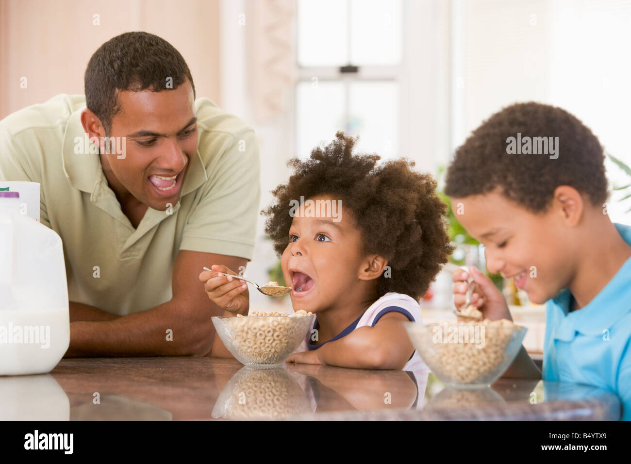 Children Eating Breakfast With Dad Stock Photo - Alamy