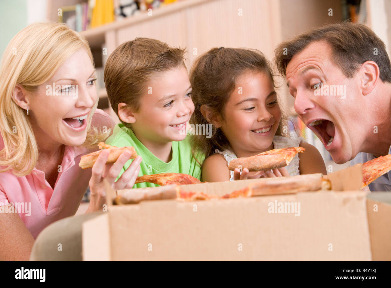 Hispanic family eating pizza together hi-res stock photography and ...