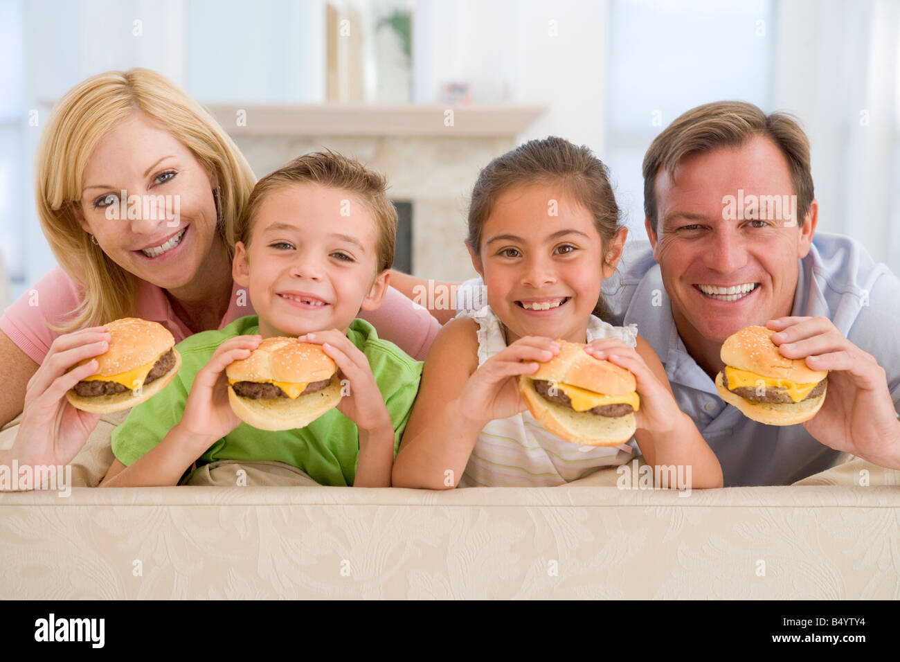 Family Eating Cheeseburgers Together Stock Photo - Alamy