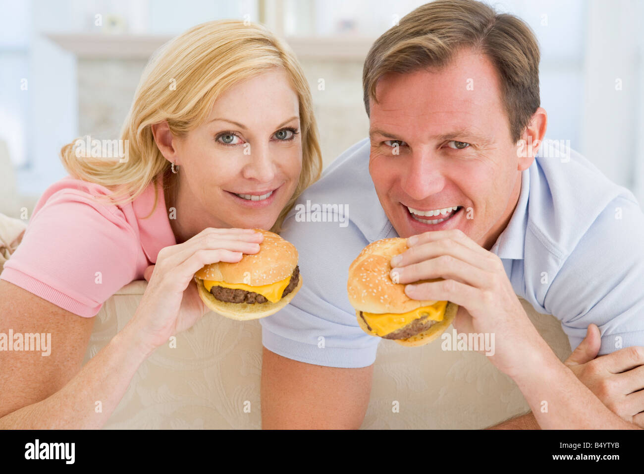 Couple eating burgers home hi-res stock photography and images - Alamy