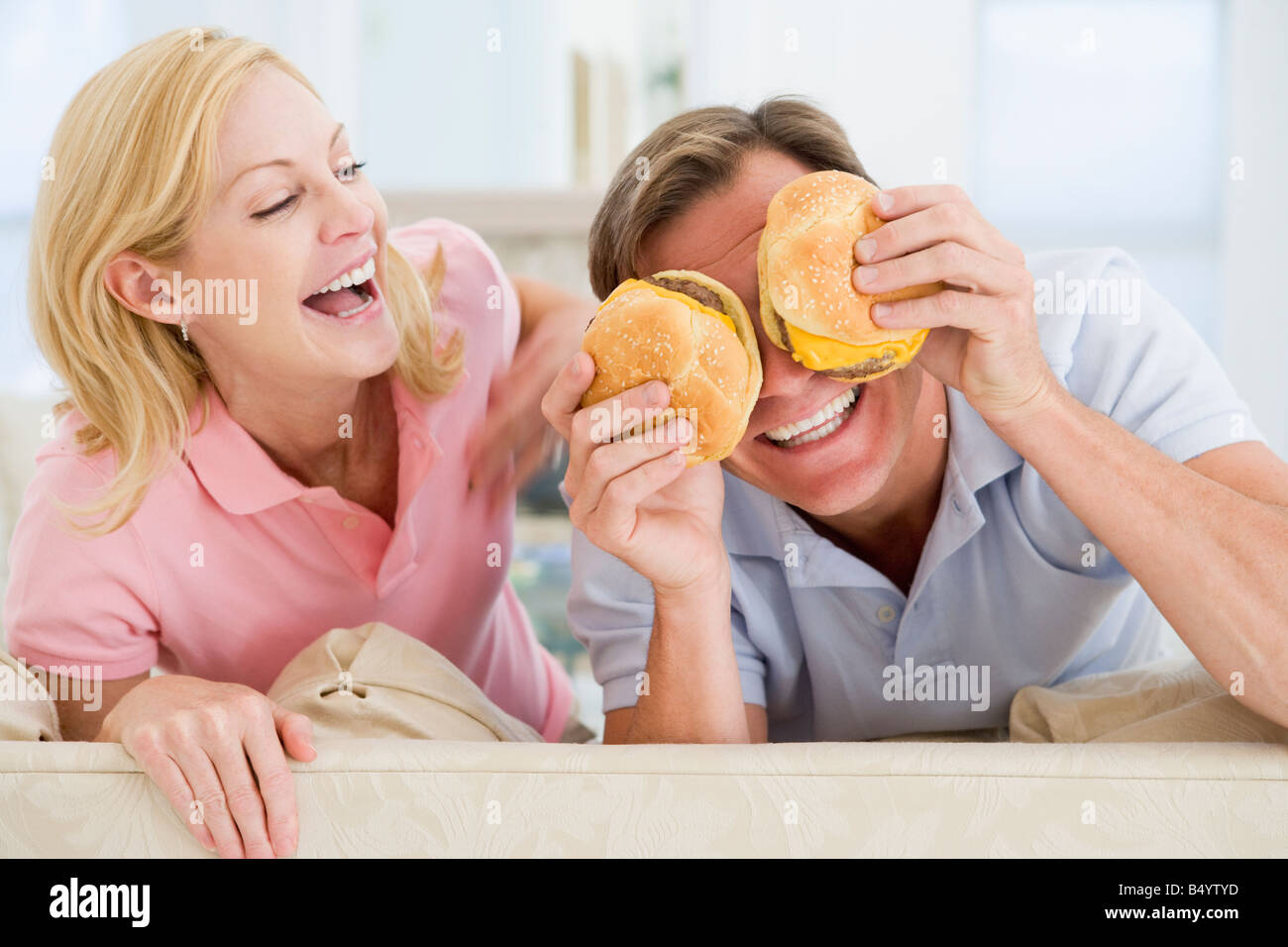 Couple Enjoying Burgers Together Stock Photo - Alamy