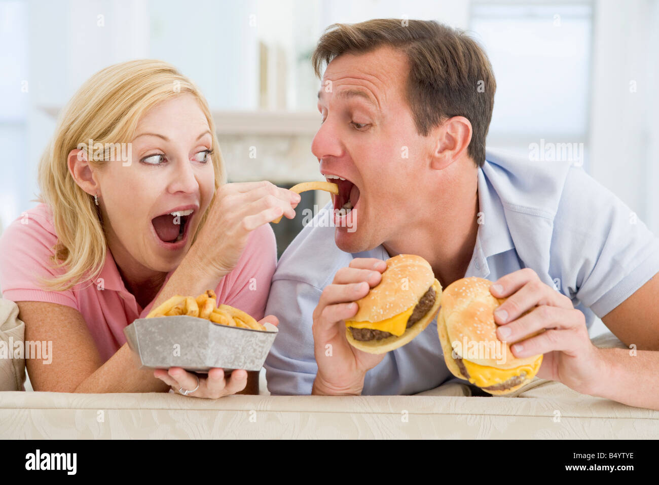 Couple Enjoying Burgers Together Stock Photo - Alamy