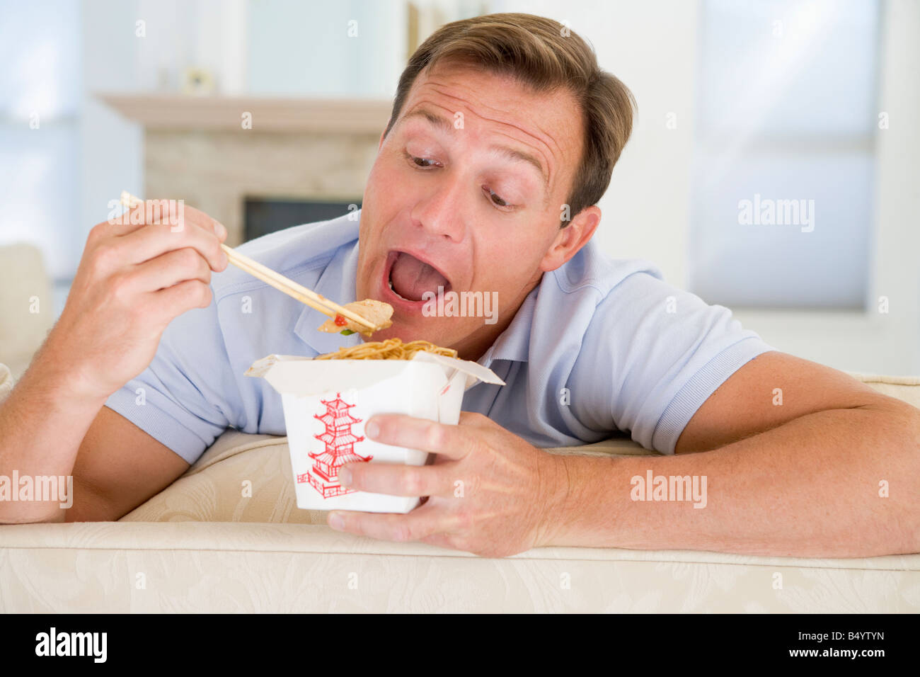 Man Eating Takeaways With Chopsticks Stock Photo - Alamy