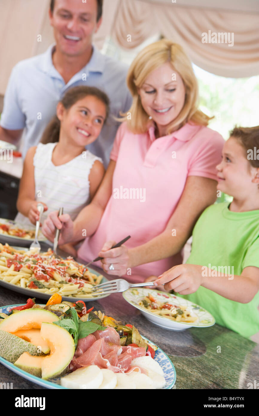Mother Serving Up Dinner For Family Stock Photo - Alamy