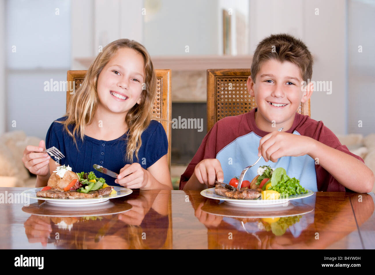 Brother And Sister Eating Meal Together Stock Photo - Alamy