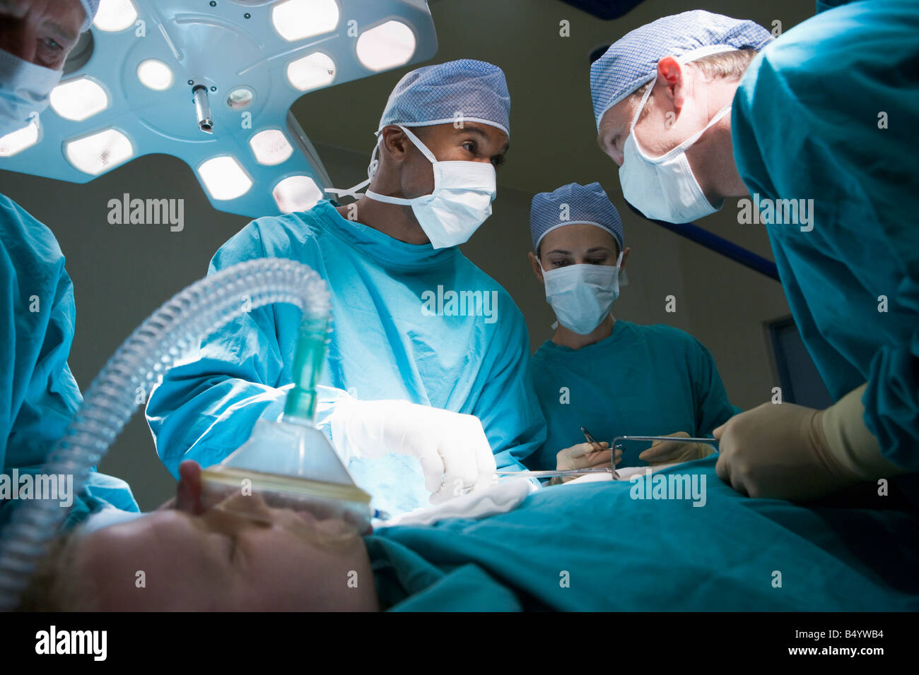 Three Surgeons Operating On A Patient Stock Photo - Alamy