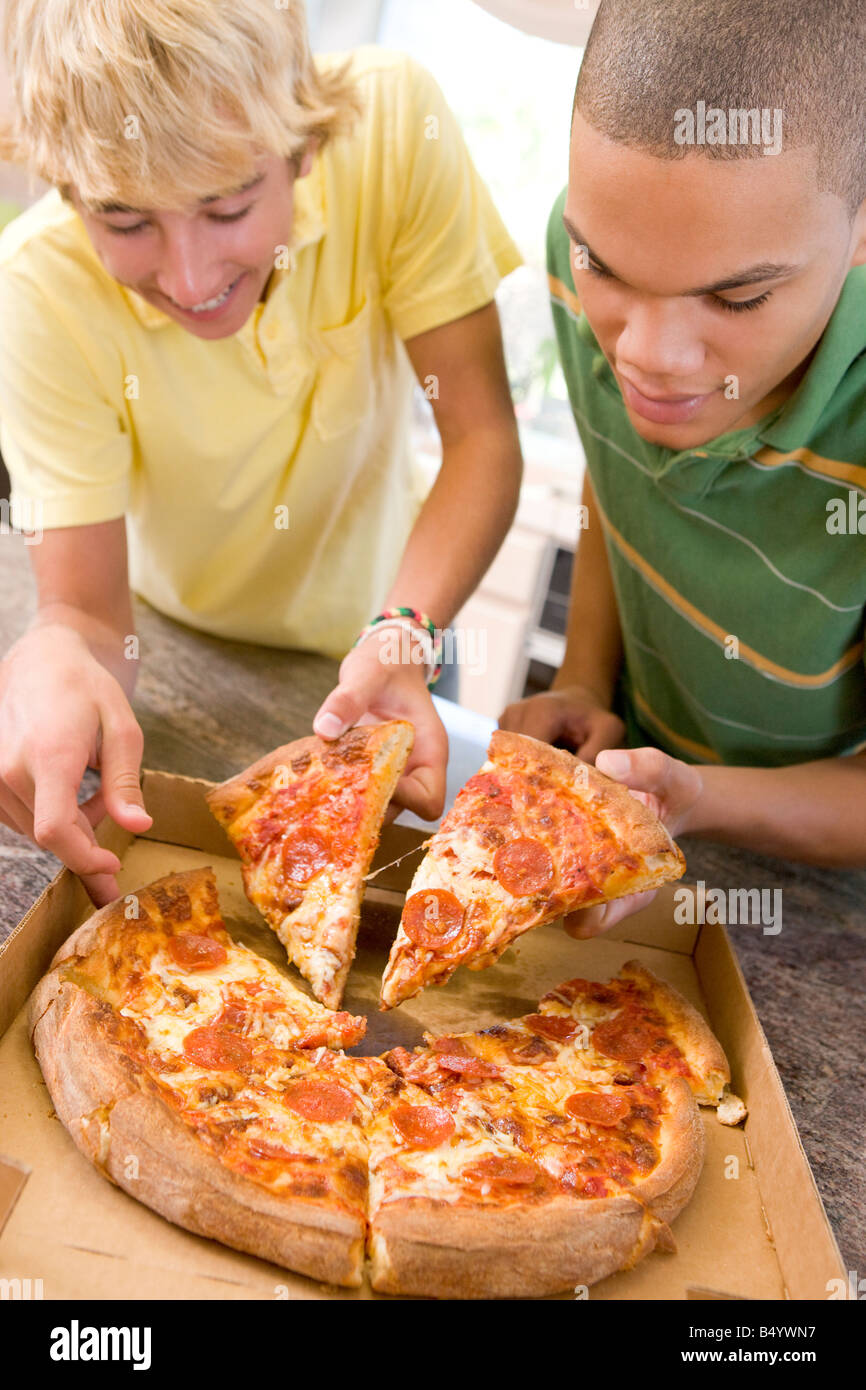 Teenage Boys Eating Pizza Stock Photo - Alamy