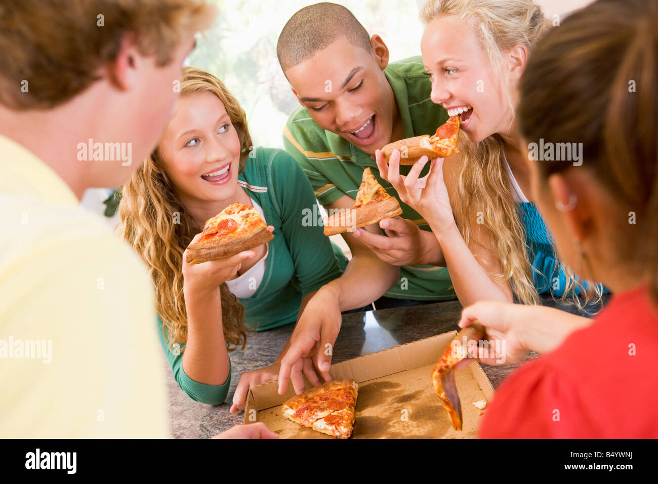 Group Of Teenagers Eating Pizza Stock Photo - Alamy