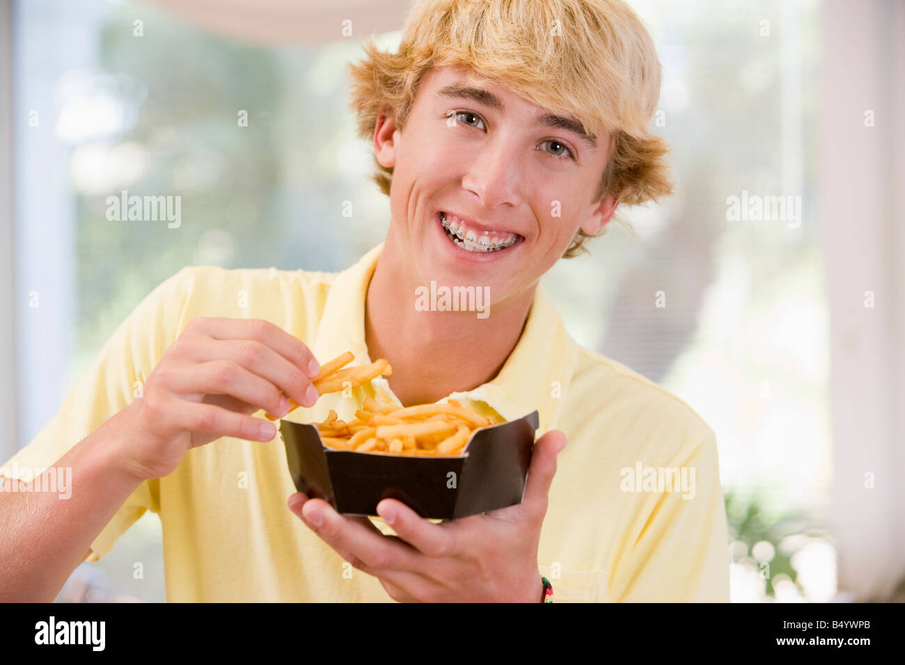 Teenage Boy Eating French Fries Stock Photo - Alamy
