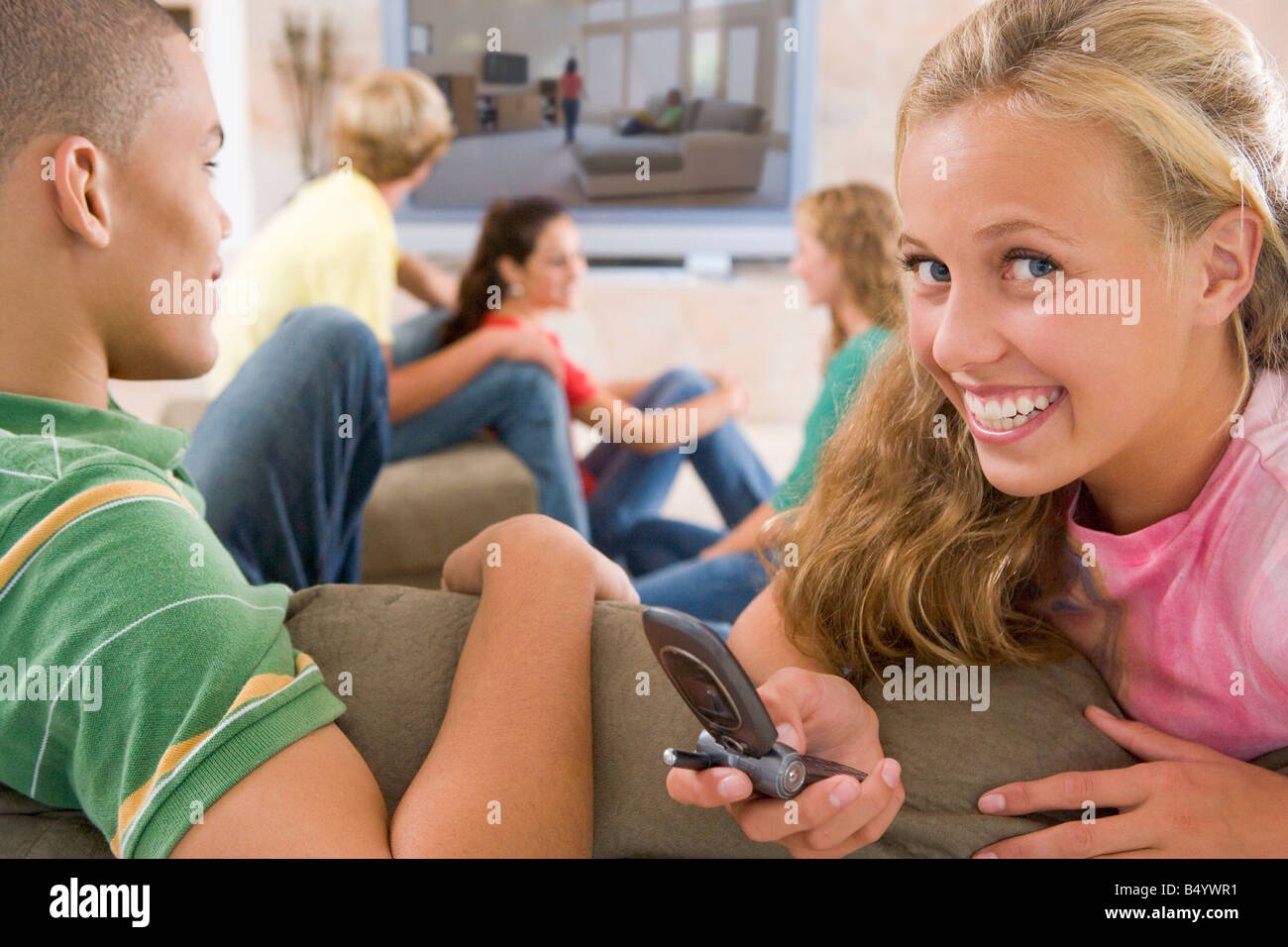 Teenagers Hanging Out In Front Of Television Using Mobile Phones Stock ...