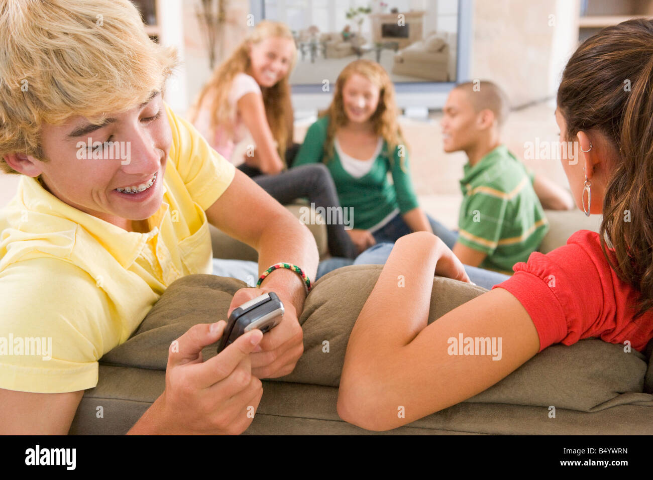 Teenagers Hanging Out In Front Of Television Using Mobile Phones Stock ...