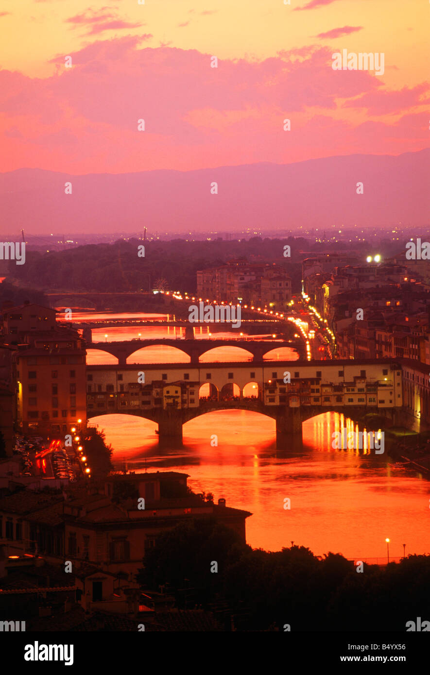 Ponte Vecchio and other bridges over Arno River under sunset skies in ...