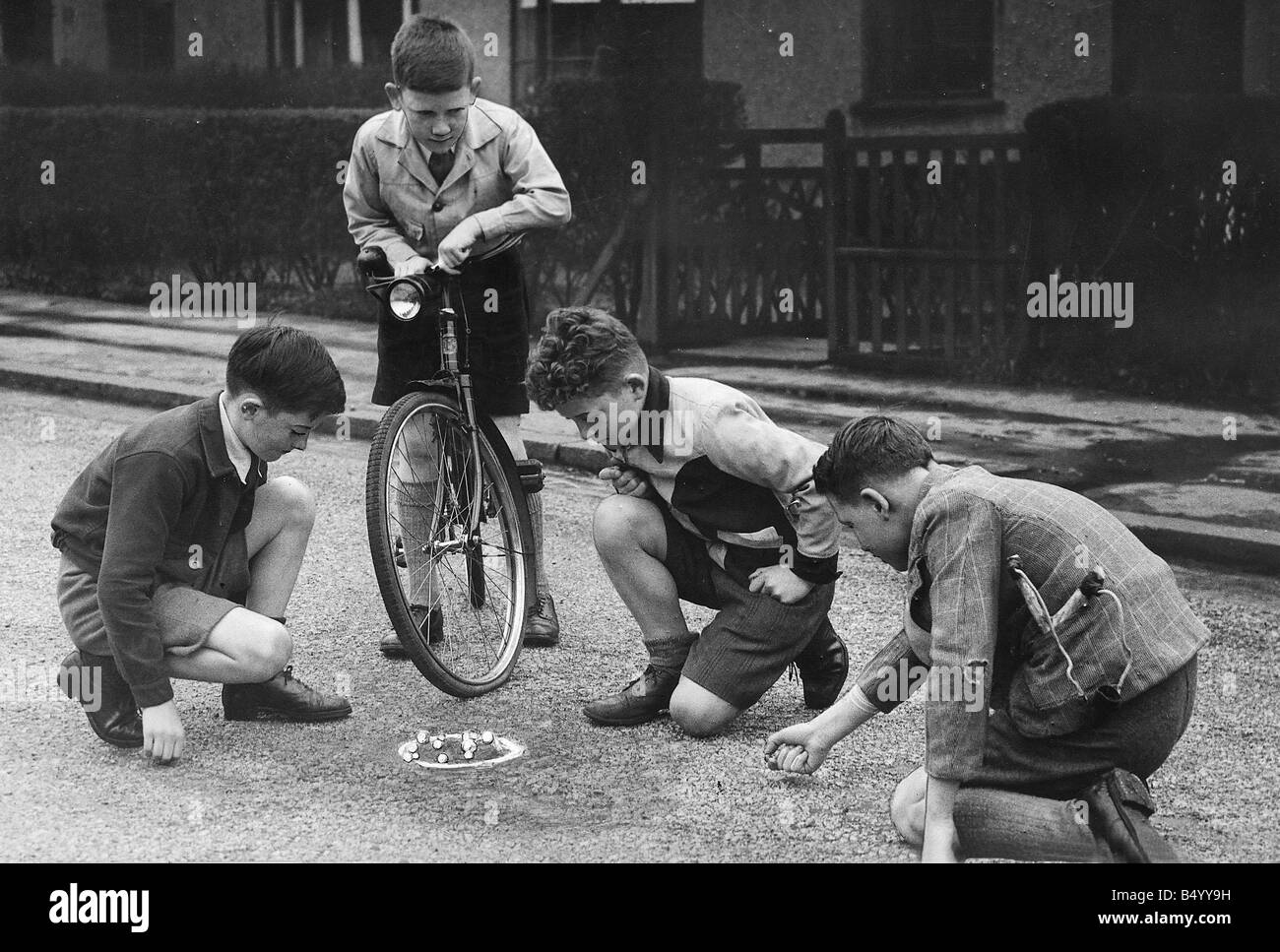 Children playing marbles game in the street 1947 Stock Photo - Alamy