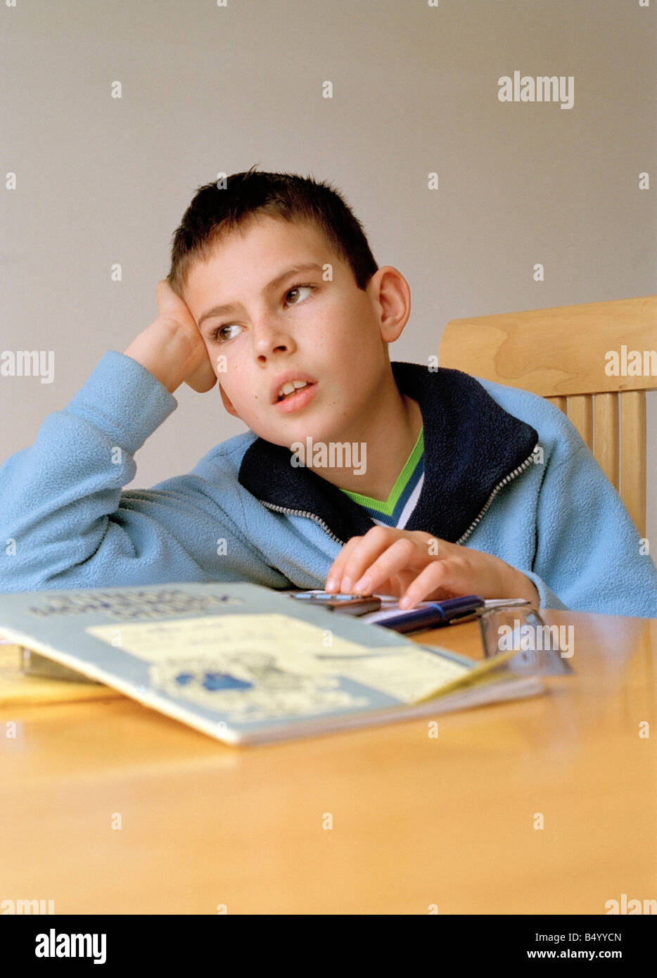 Bored boy doing his homework Stock Photo - Alamy