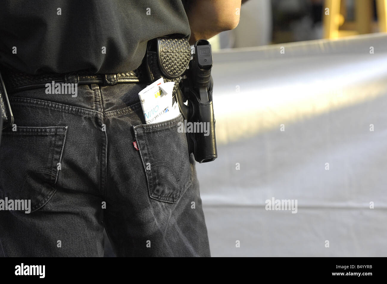 A police officer for the city of Orange CA patrols the area at a street ...