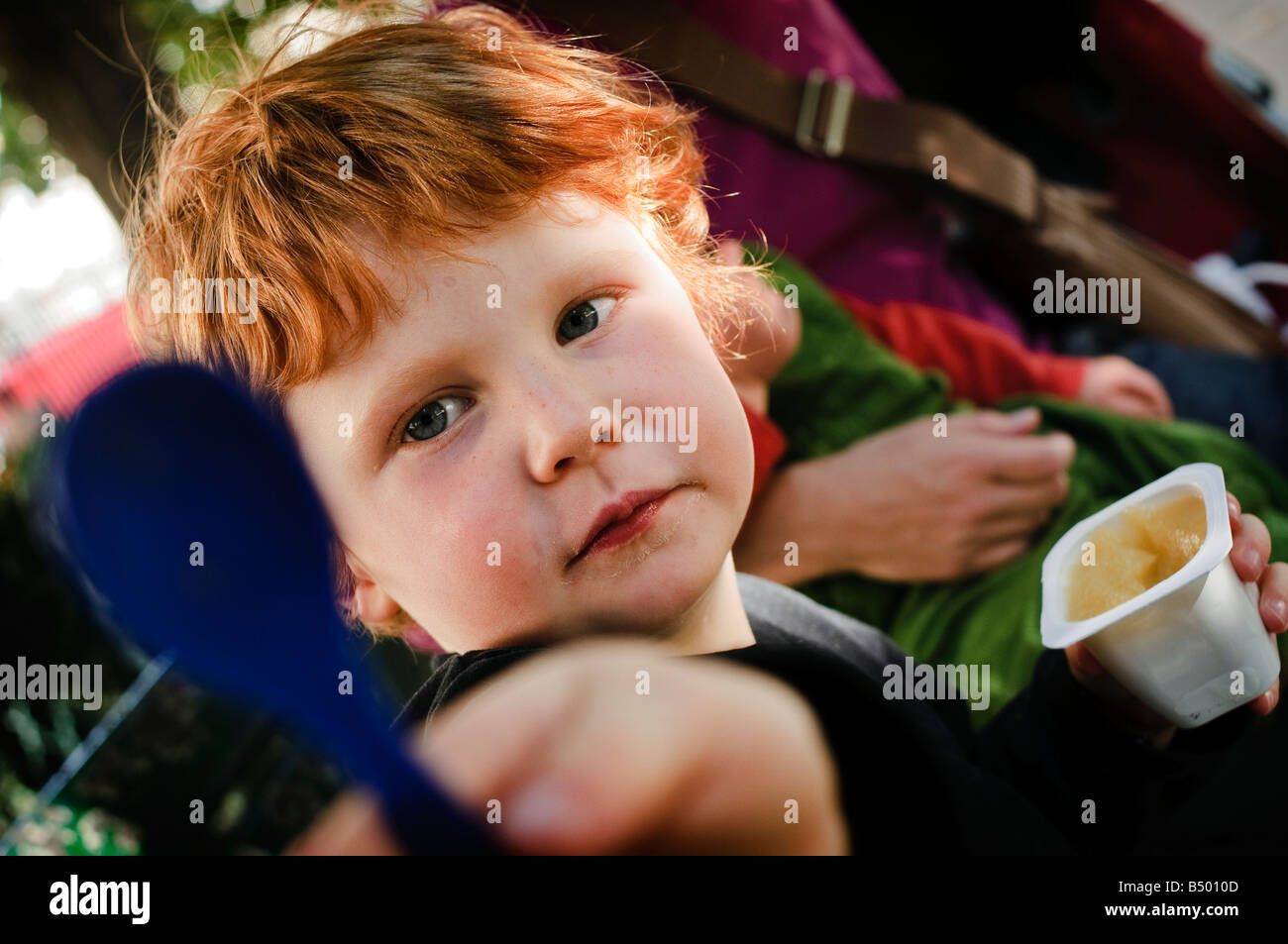 Young boy having a snack Stock Photo - Alamy