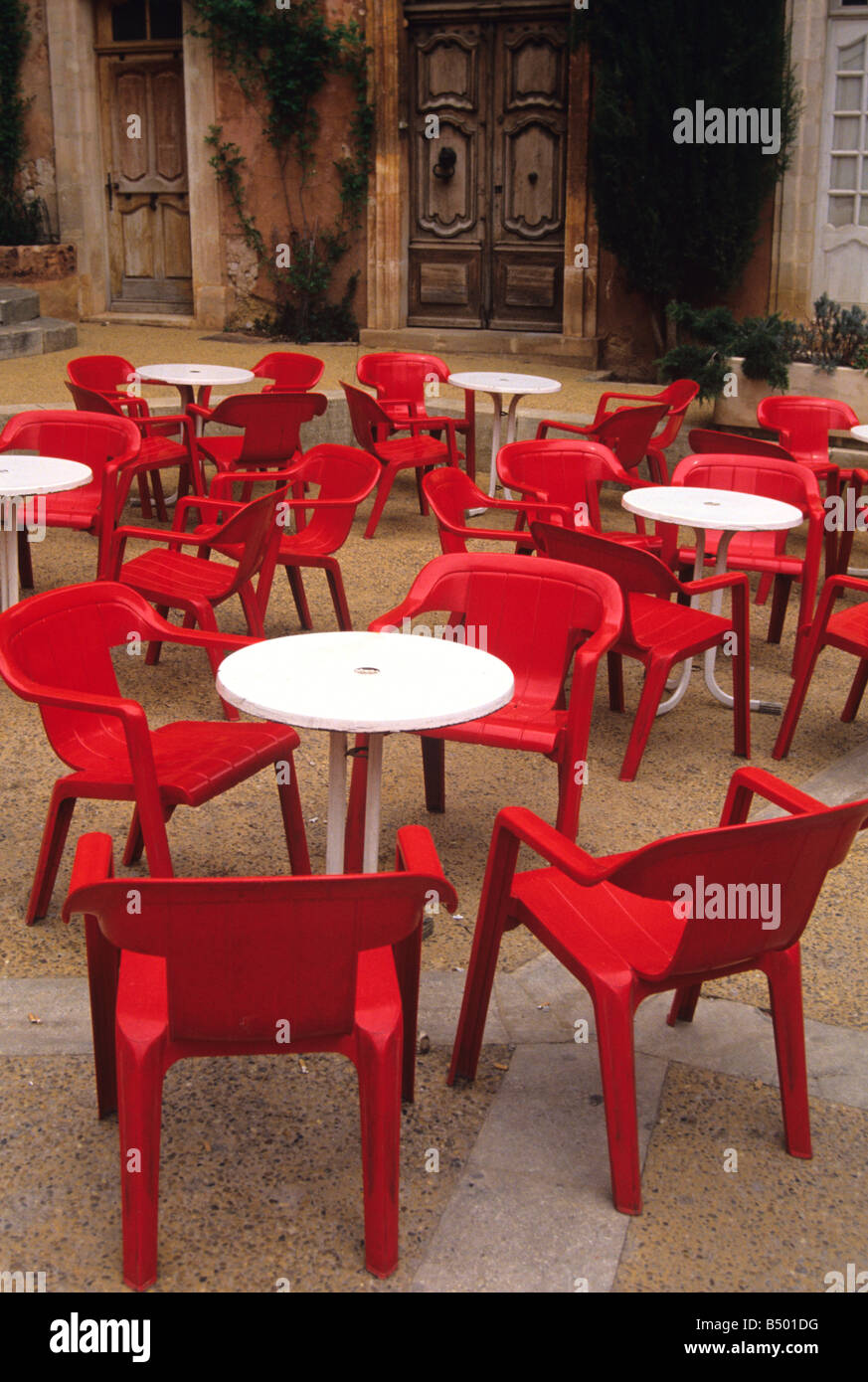 Bright red chairs in a cafe in Roussillon Provence Stock Photo - Alamy