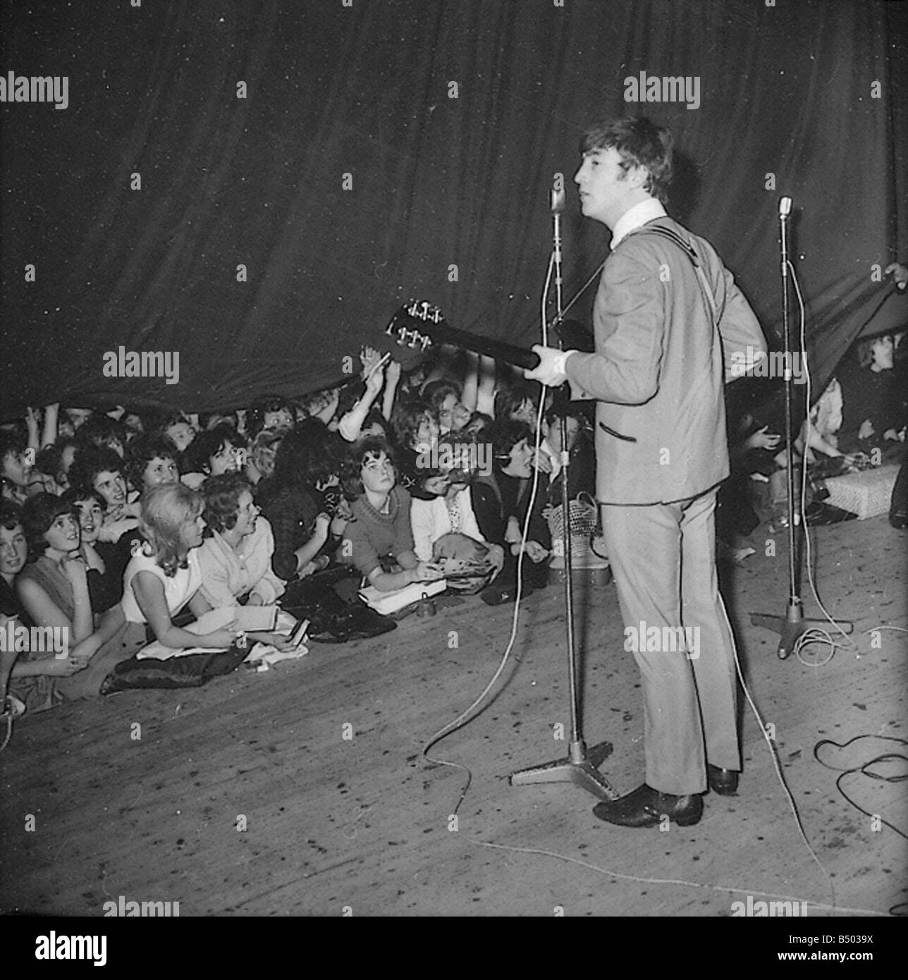 Beatles files 1963 John Lennon on stage during Beatles concert in ...