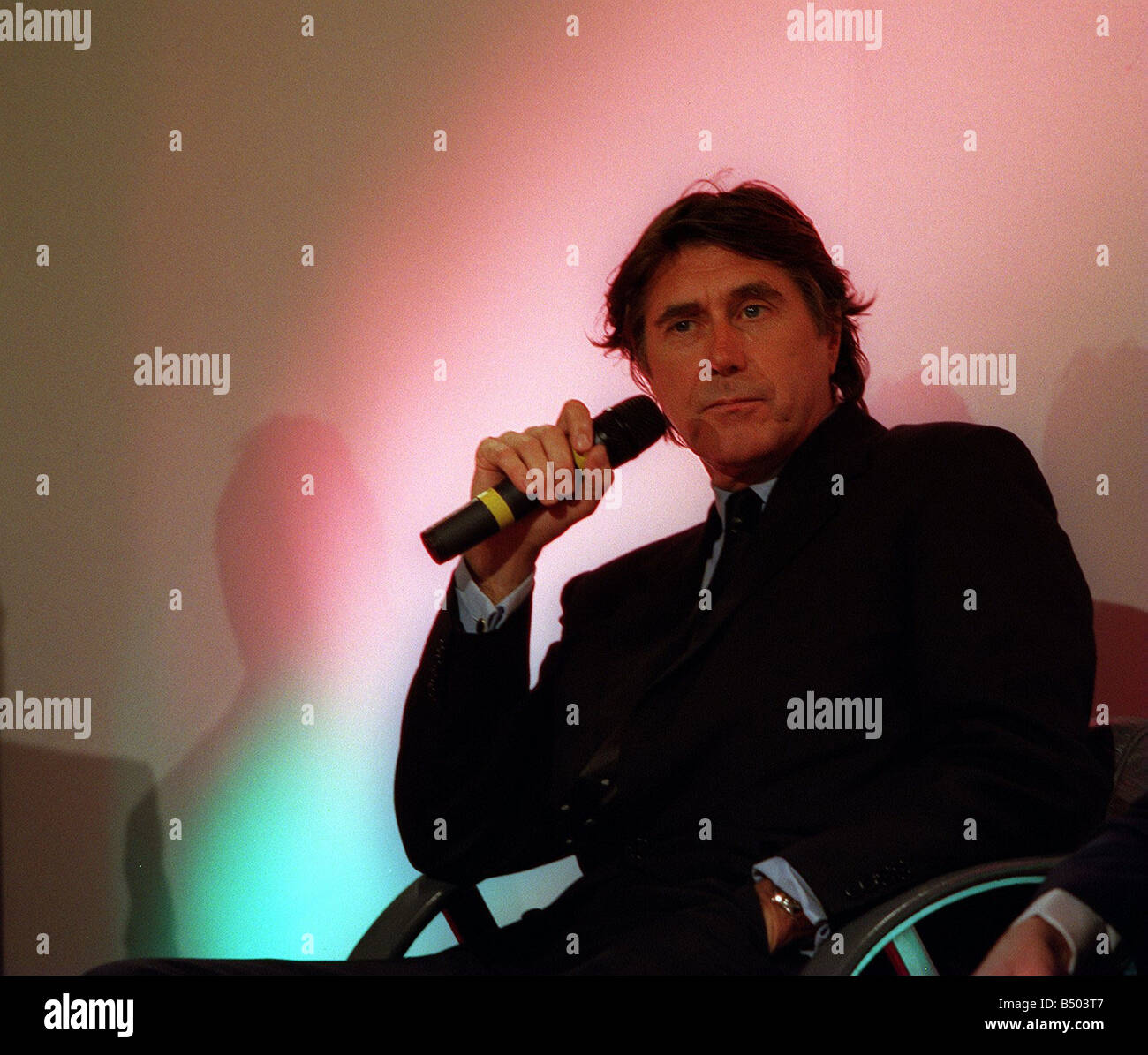 Bryan Ferry with microphone at press conference February 2001 Stock ...
