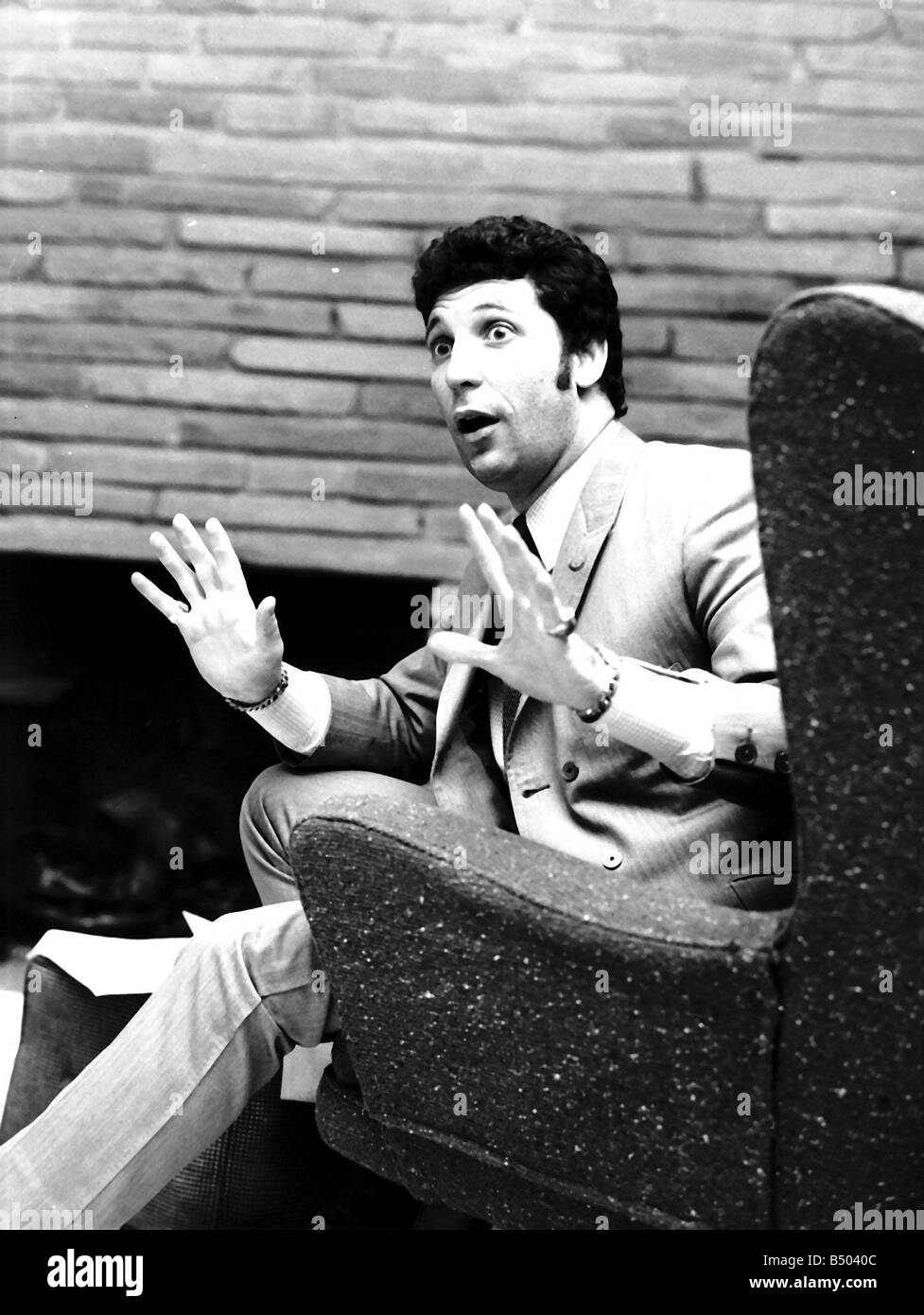 Tom Jones singer hands up sitting on armchair Stock Photo - Alamy