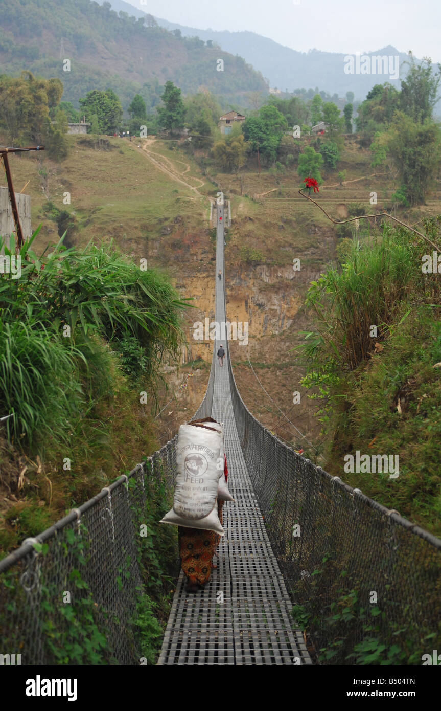 Bridge crossing and woman carrying Stock Photo - Alamy