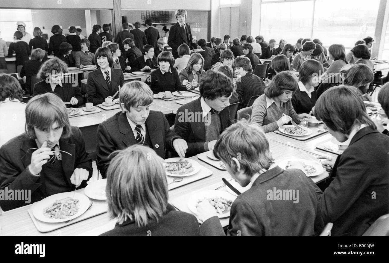 Pupils enjoying their school dinners in a packed dining hall Stock ...