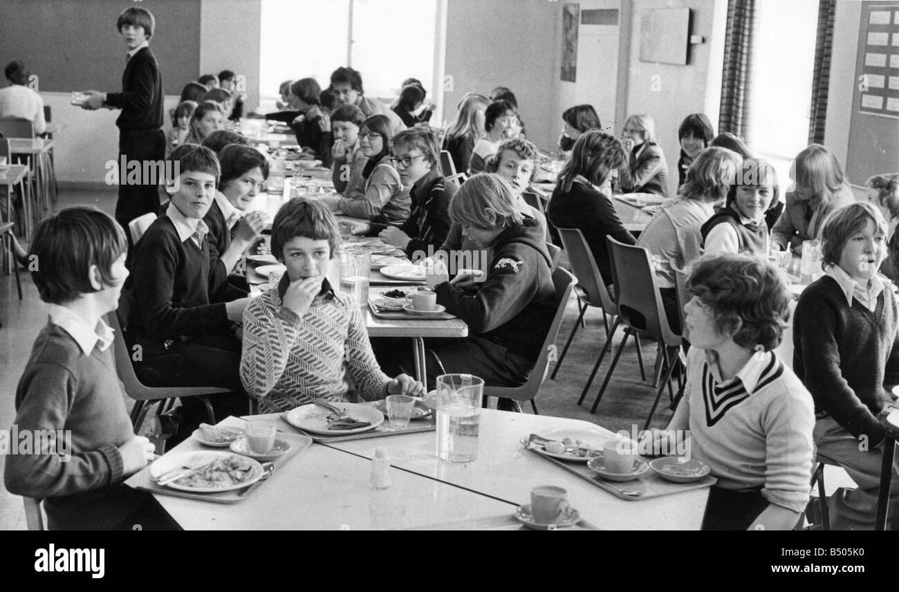 Pupils enjoying their school dinners in a packed dining hall Stock ...