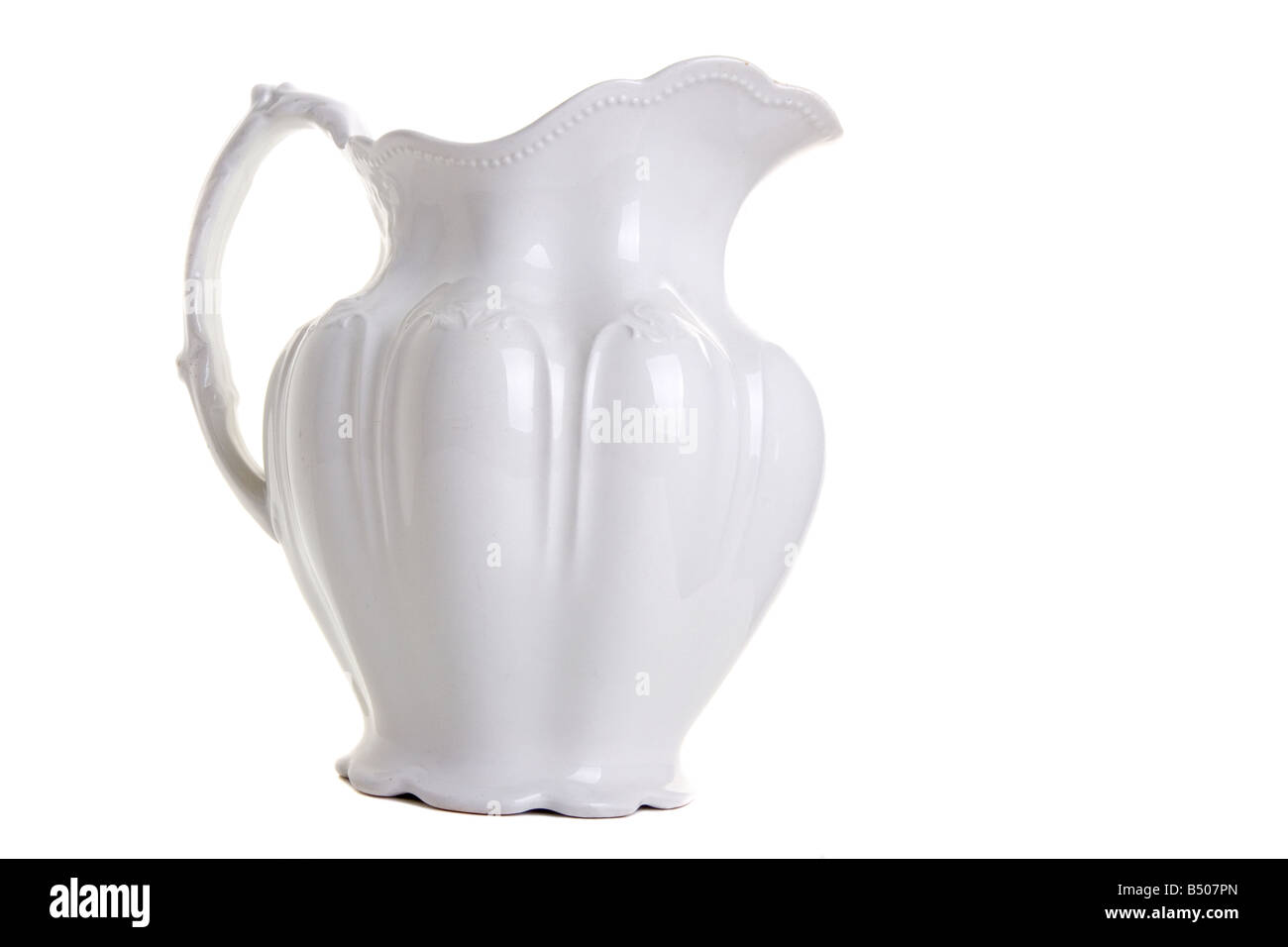 A white ceramic milk pitcher on a white background Stock Photo - Alamy