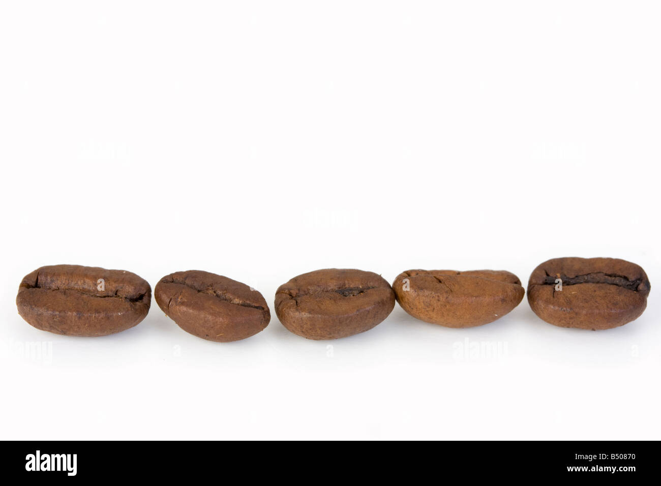 five espresso beans on white background Stock Photo - Alamy