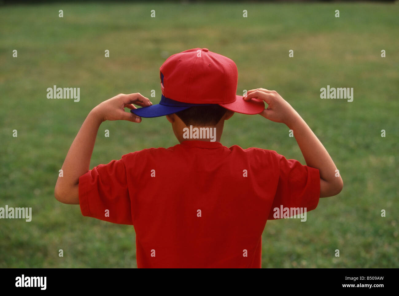 boy with 2 baseball caps Stock Photo - Alamy