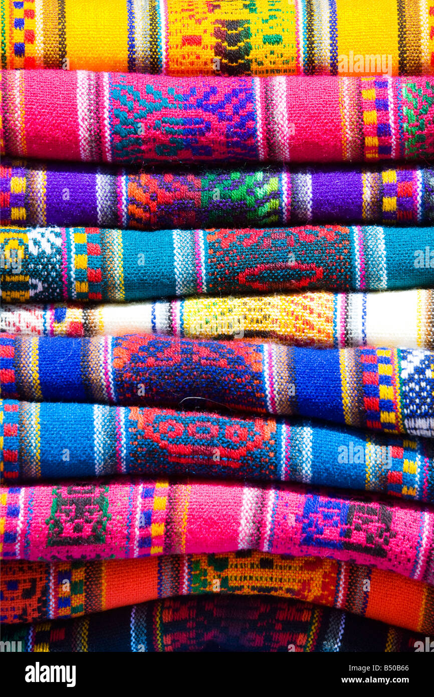 Piles of Peruvian Andean blankets folded neatly to give a colourful ...