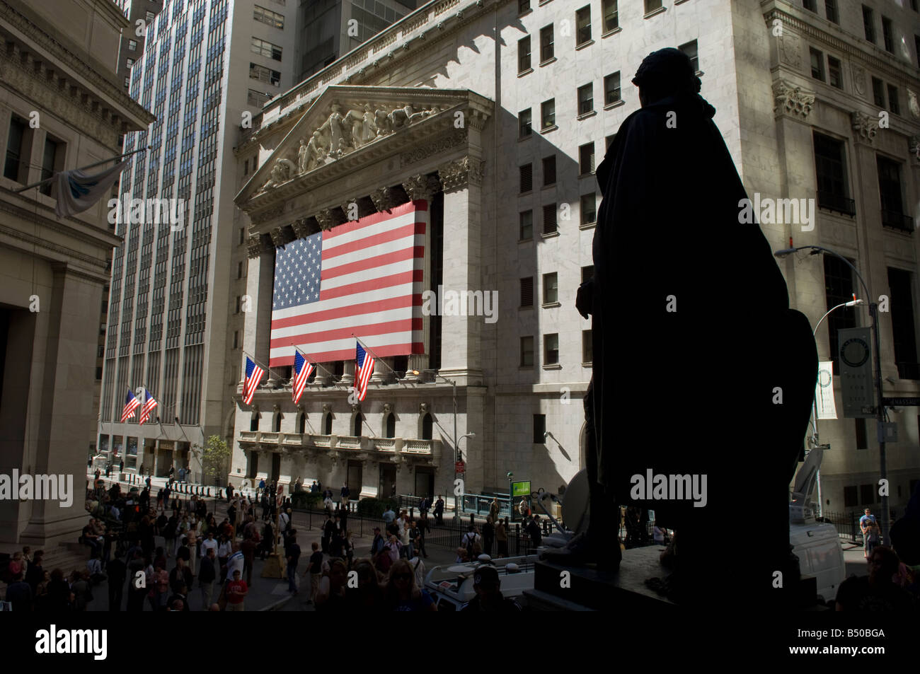Tourists and business people congregate around the New York Stock ...