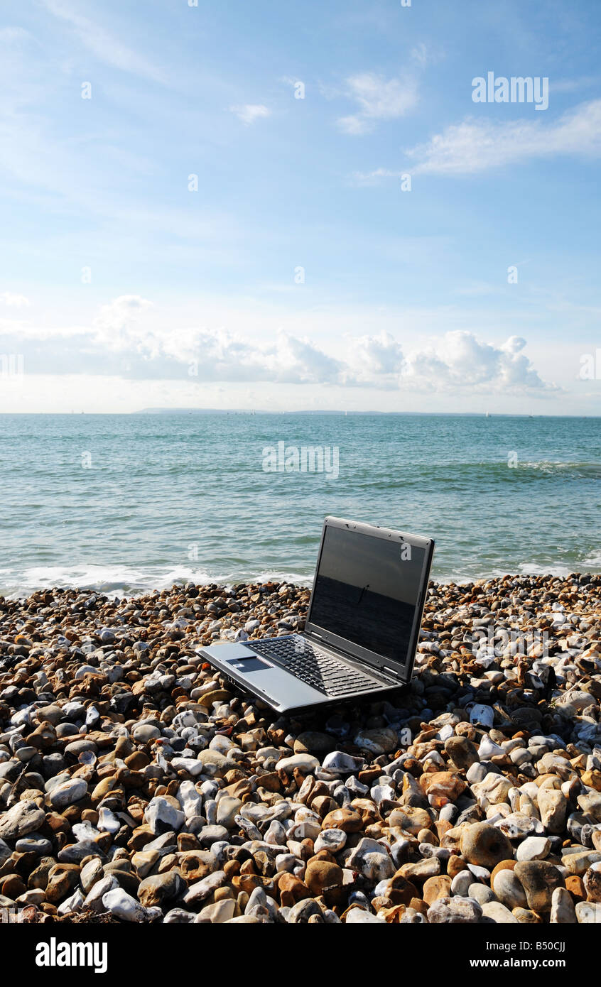 Laptop computer on beach waves hi-res stock photography and images - Alamy