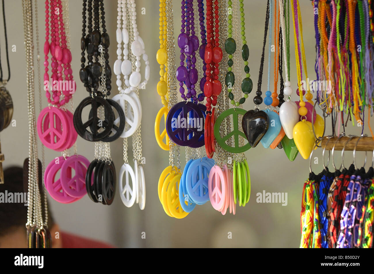 An array of plastic bead and peace symbol costume jewelry for sale ...
