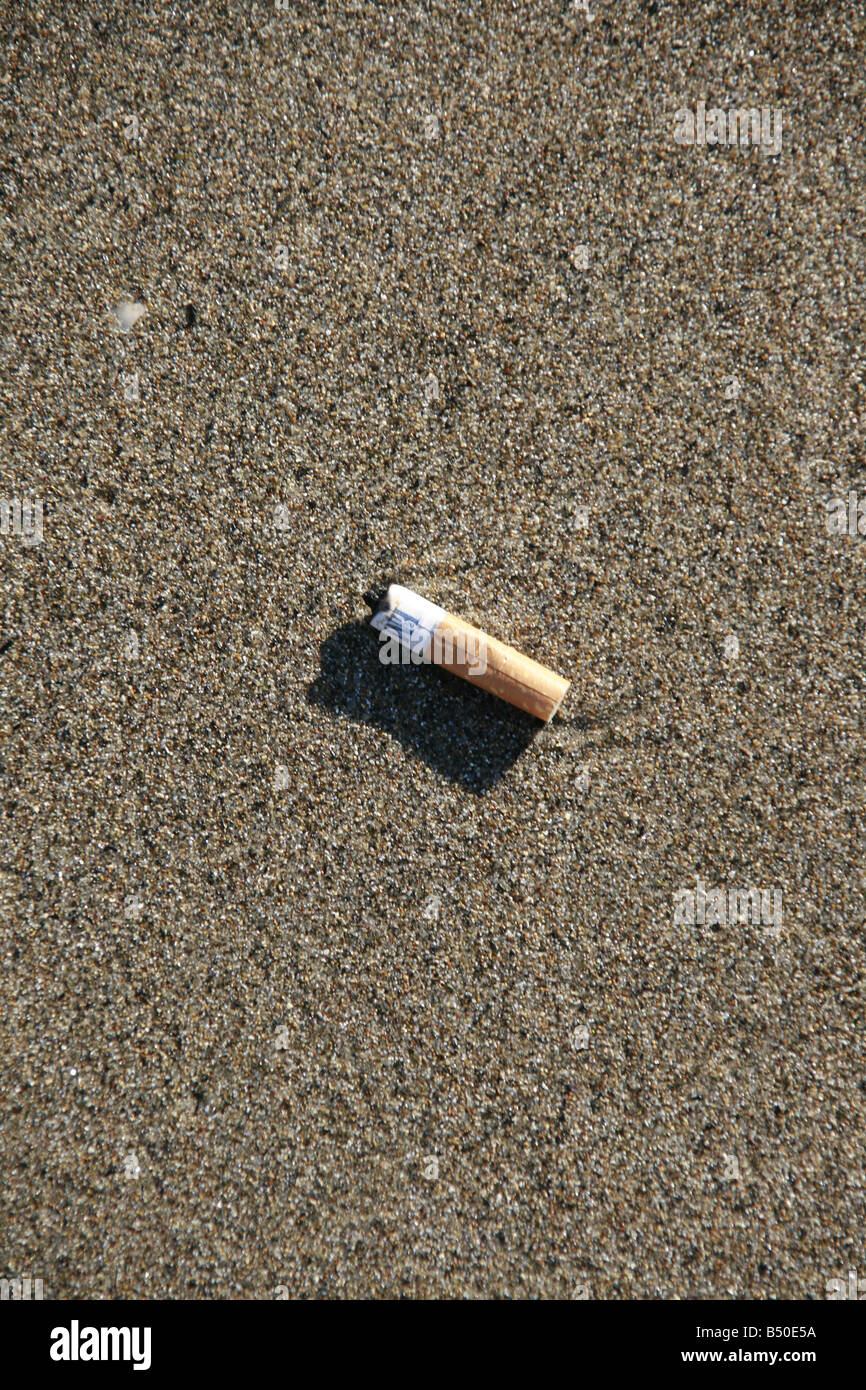 one cigarette stub discarded on street road floor Stock Photo - Alamy