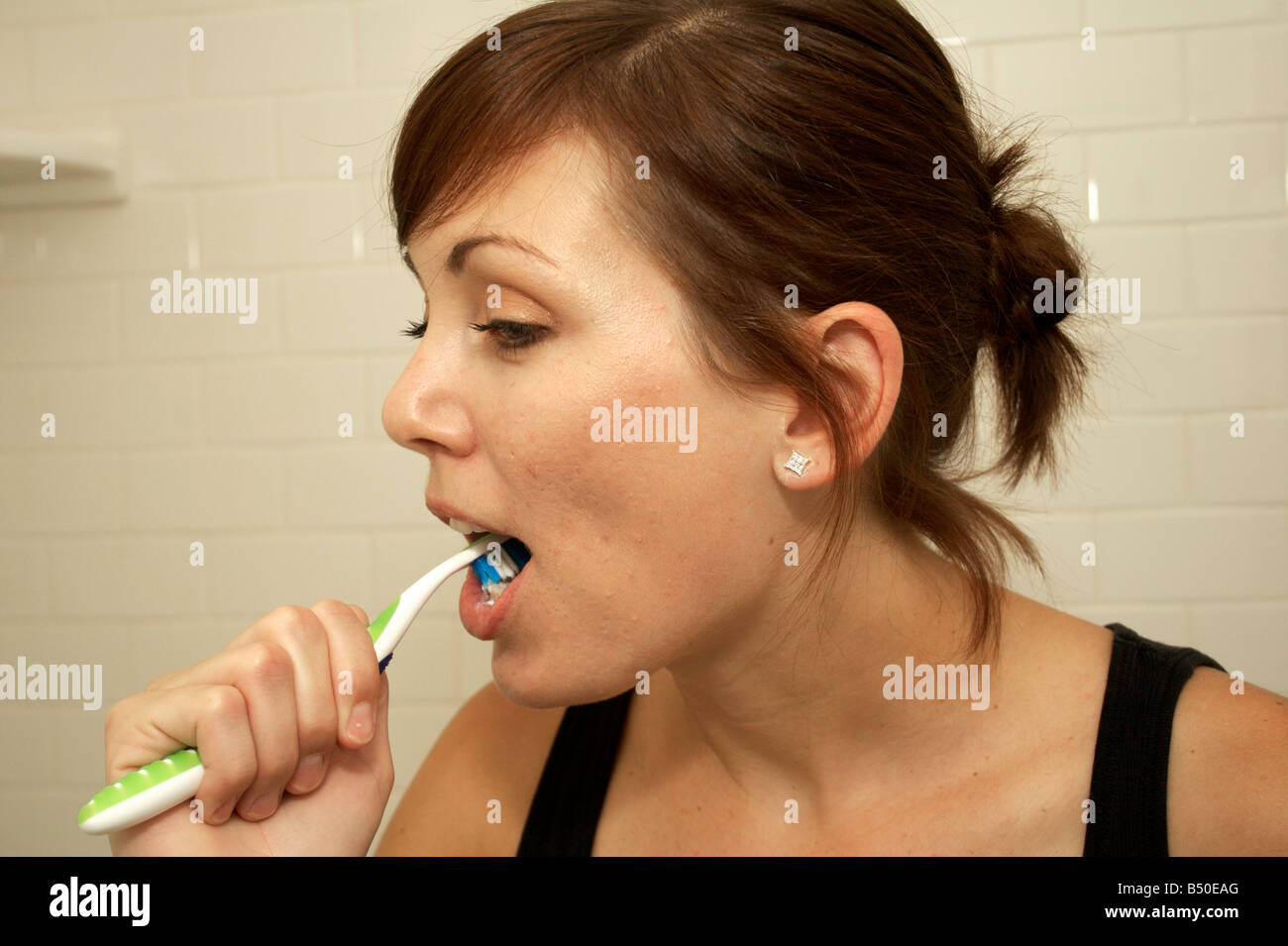 An attractive young lady brushing her teeth Stock Photo - Alamy