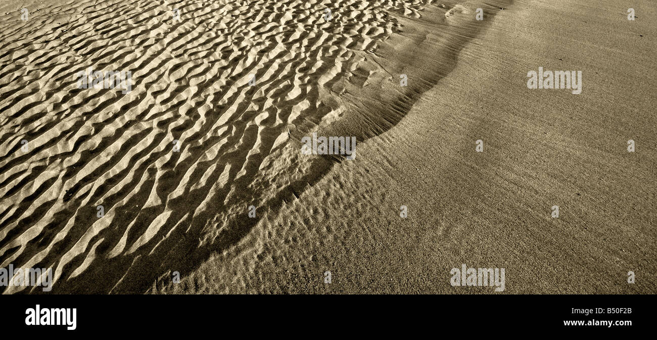 Ripples and smooth sand on a beach in a warm toned light Stock Photo ...
