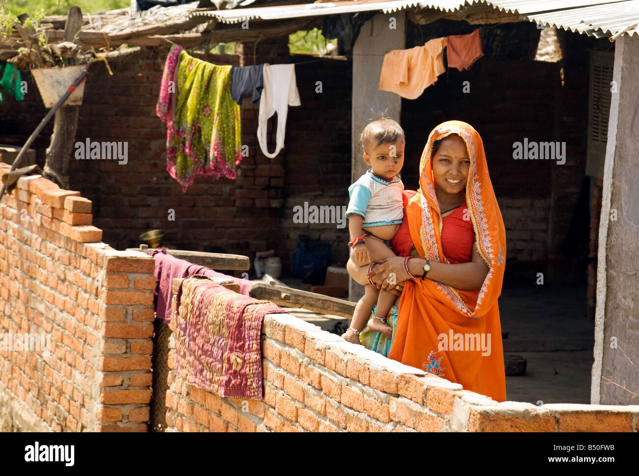 A village mother with her baby son in her house, Rajasthan, India Stock ...