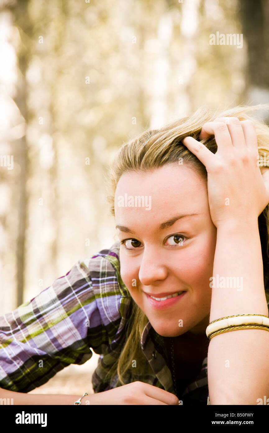 Young laying woman smiling at camera Stock Photo - Alamy