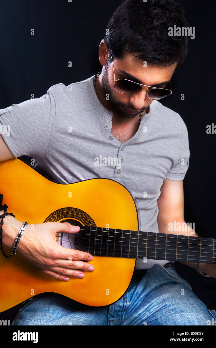 Young man playing guitar Stock Photo - Alamy