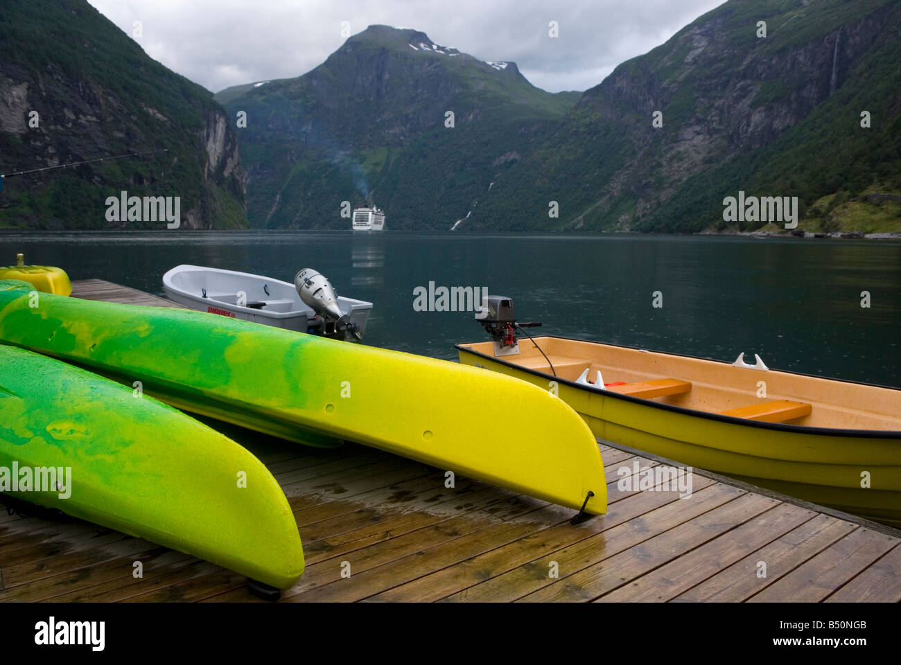 Boats resting on a pier at Geiranger fjord Stock Photo - Alamy