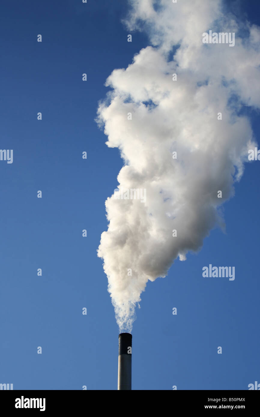 chimney billowing white smoke into blue sky Stock Photo - Alamy