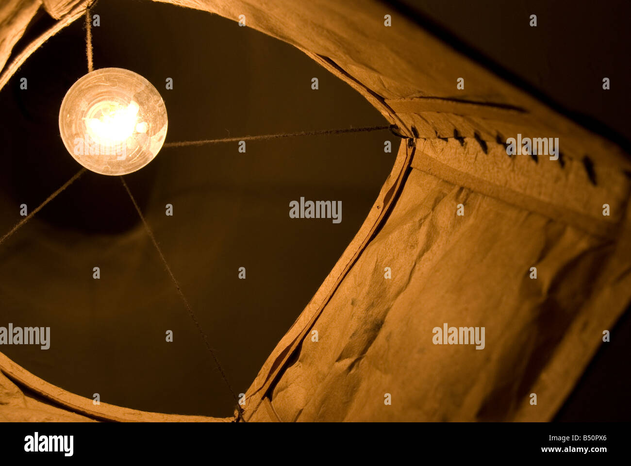 Light bulb in lampshade, photo from below. Illuminated light bulb with ...