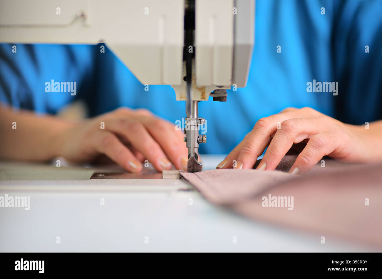 Tailor working at a textile factory Stock Photo - Alamy