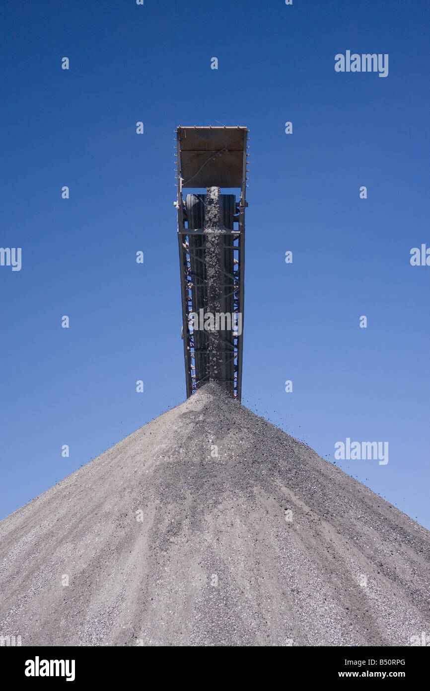 A conveyor dumping rock Stock Photo - Alamy