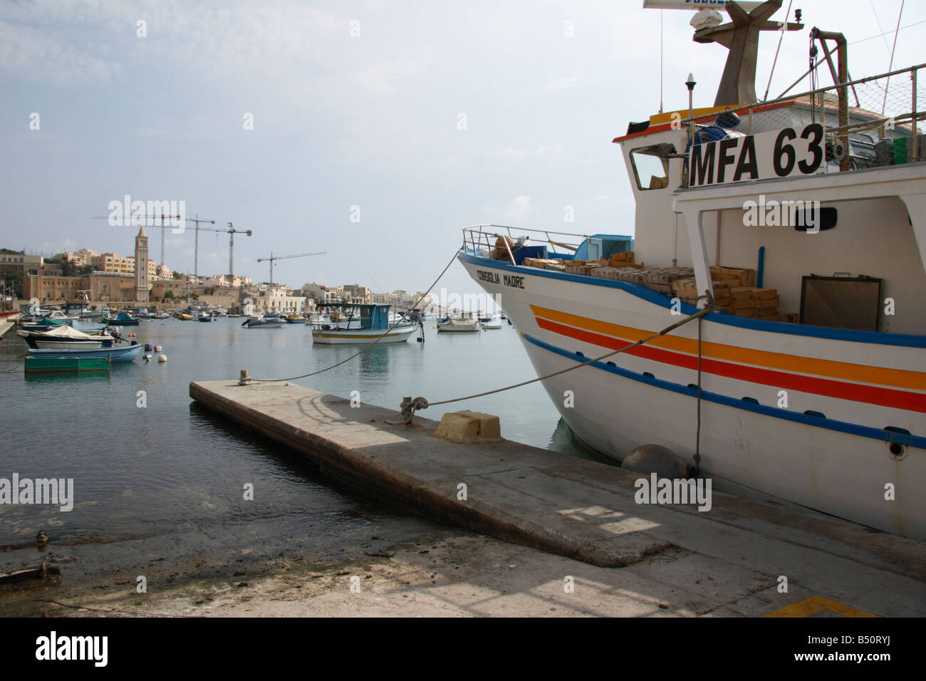 A fishing boat tied up at the quay in Marsaskala harbour, Malta Stock ...