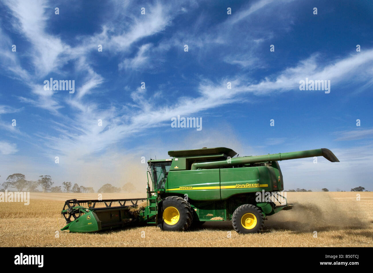 Header machine harvesting wheat crop in the Wimmera region of Australia ...