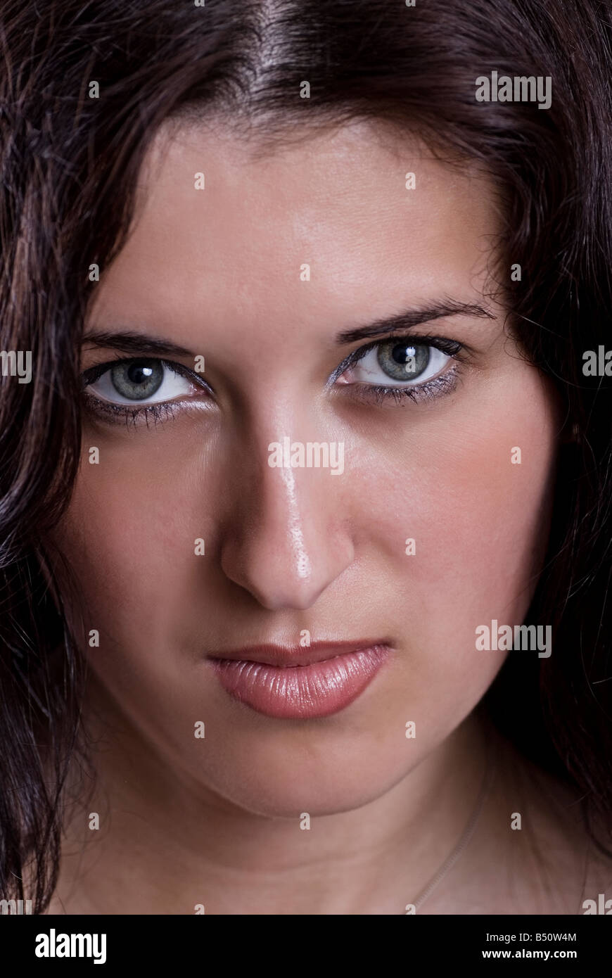 Beautiful young woman face looking at camera Stock Photo - Alamy