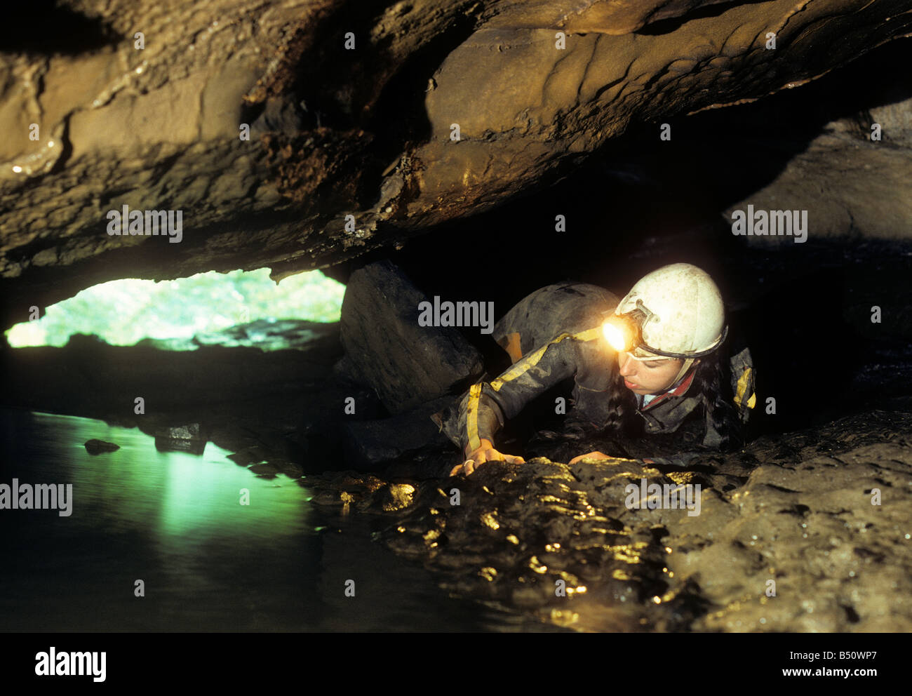 Female caver crawling into cave Clydach Gorge Wales UK Stock Photo - Alamy